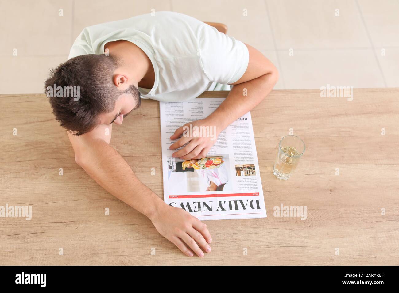 Young man sleeping newspaper hi-res stock photography and images - Alamy