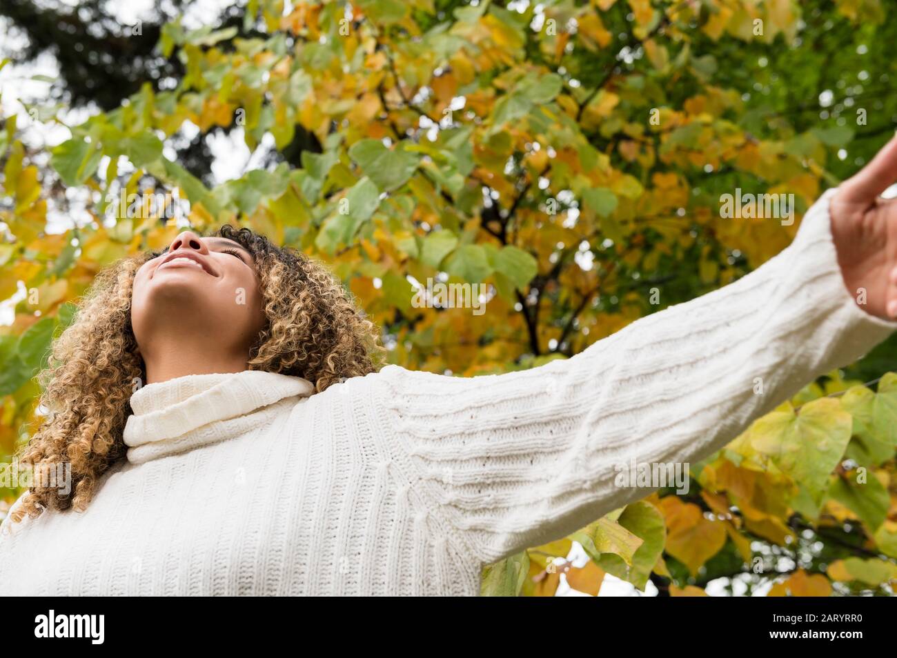 Woman autumn outstretched arms one person hi-res stock photography and ...