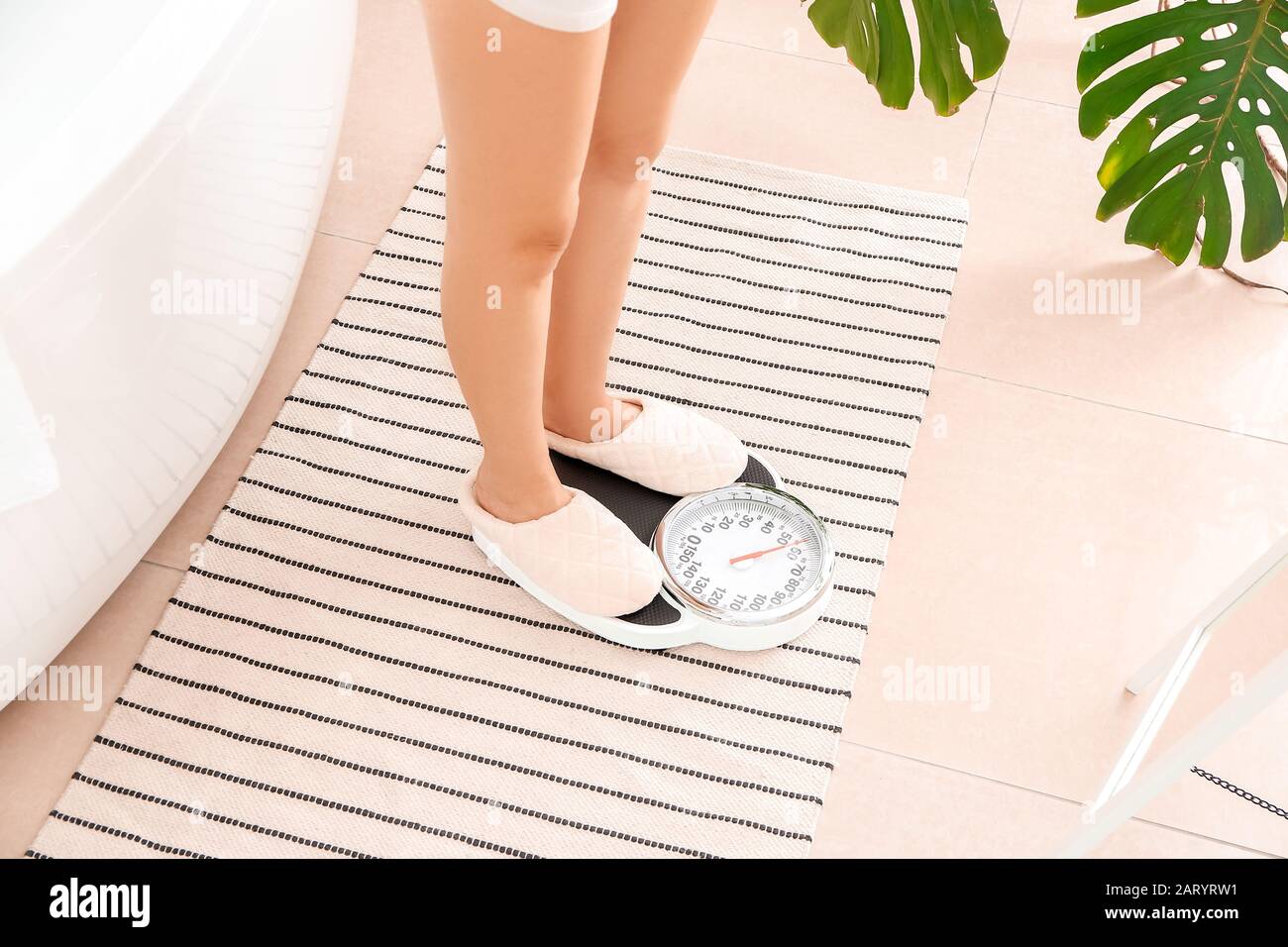 Woman on bathroom scales hi-res stock photography and images - Alamy