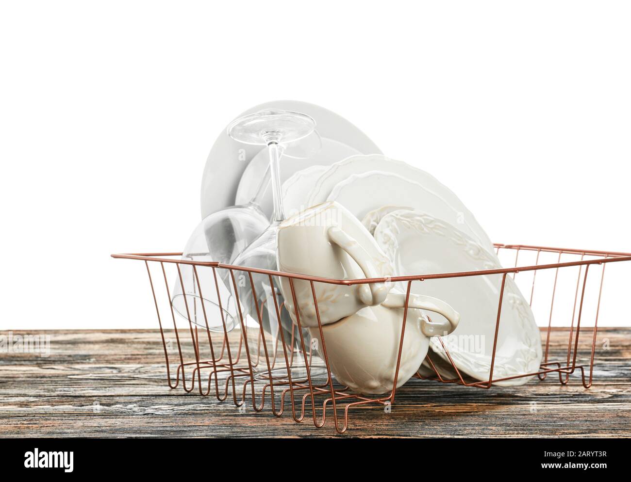 Set of clean dishes on table against white background Stock Photo - Alamy