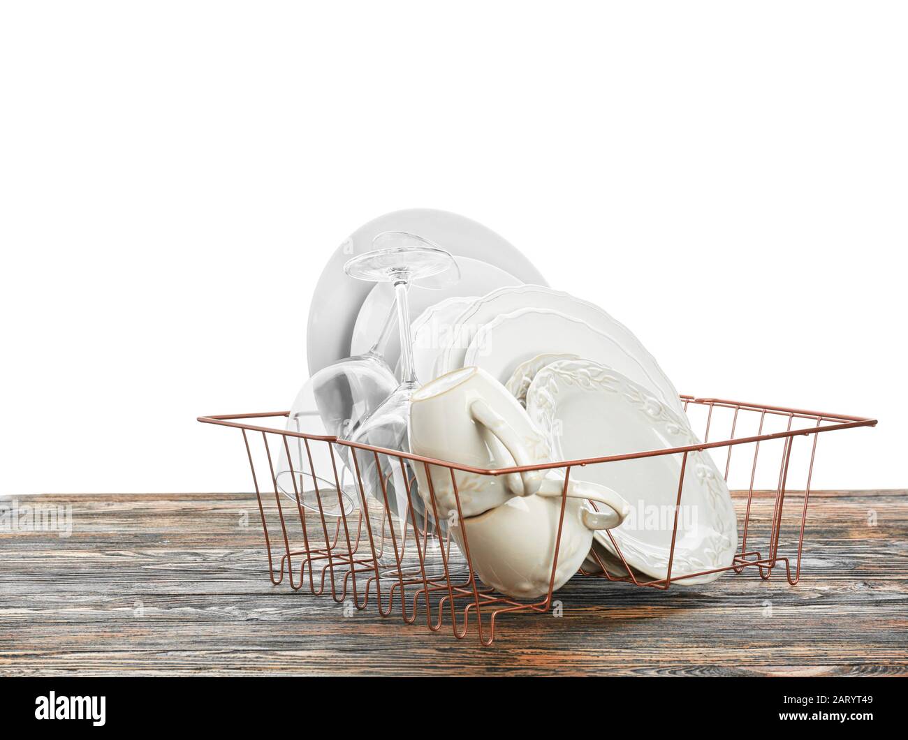 Set of clean dishes on table against white background Stock Photo - Alamy