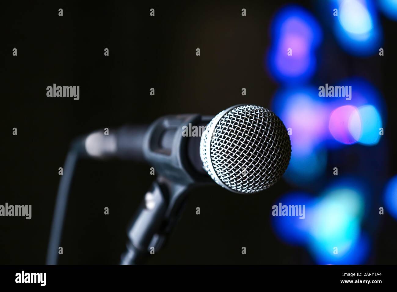 Microphone on dark background with defocused lights Stock Photo - Alamy