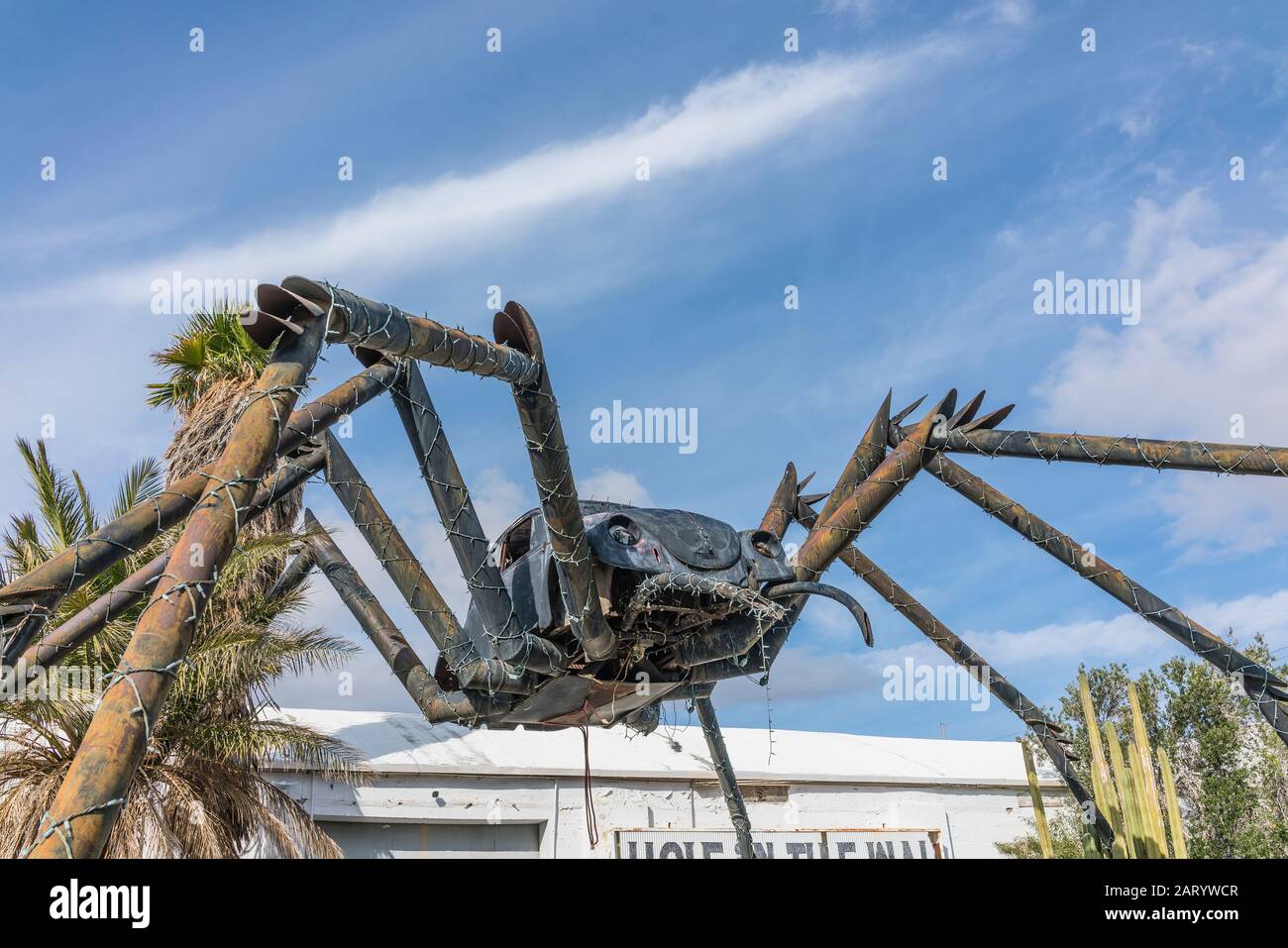 A gigantic spider sculpture made with welded parts including a ...