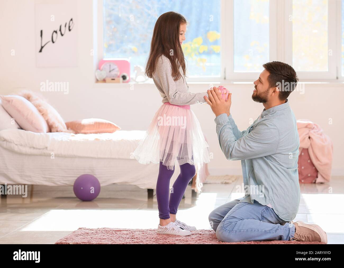 Little daughter greeting her father at home Stock Photo - Alamy