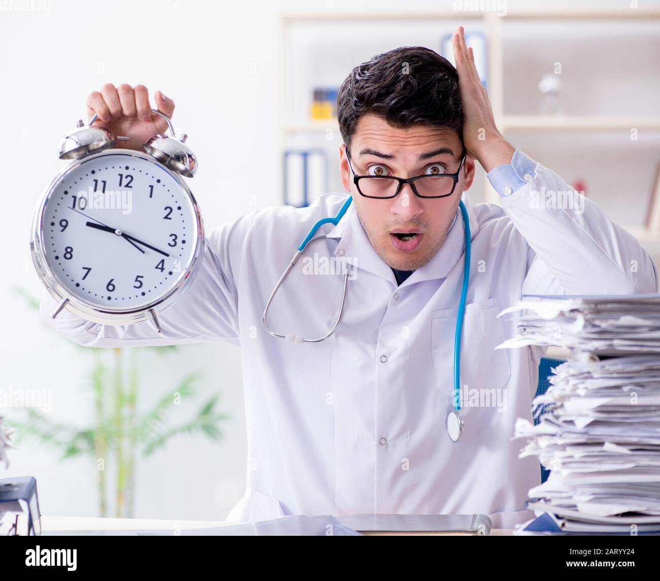 The doctor with alarm clock in urgent check-up concept Stock Photo - Alamy