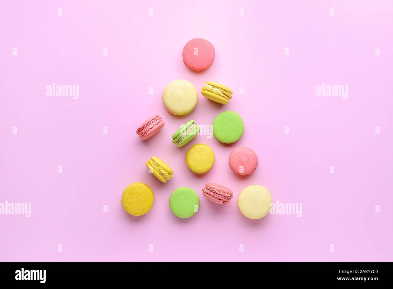Christmas tree shape made of tasty macarons on color background Stock ...