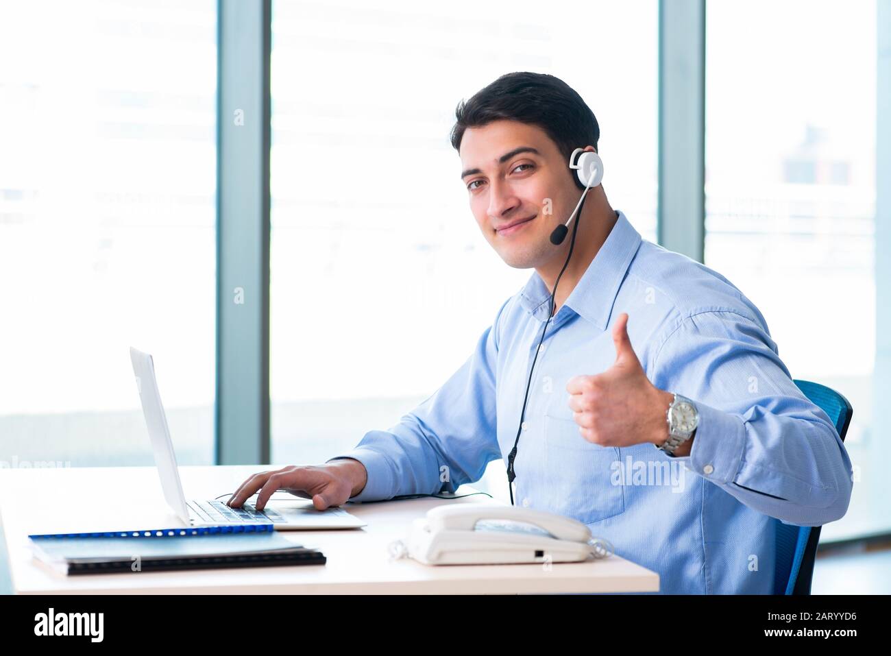 The male call-center operator in business concept Stock Photo - Alamy