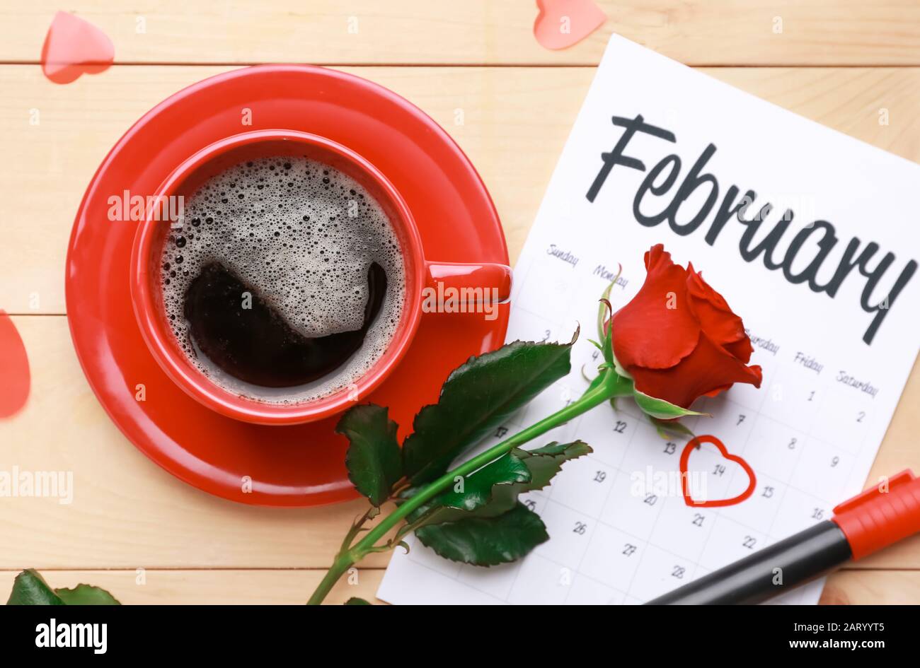 Calendar of February, cup with coffee and rose on wooden background ...
