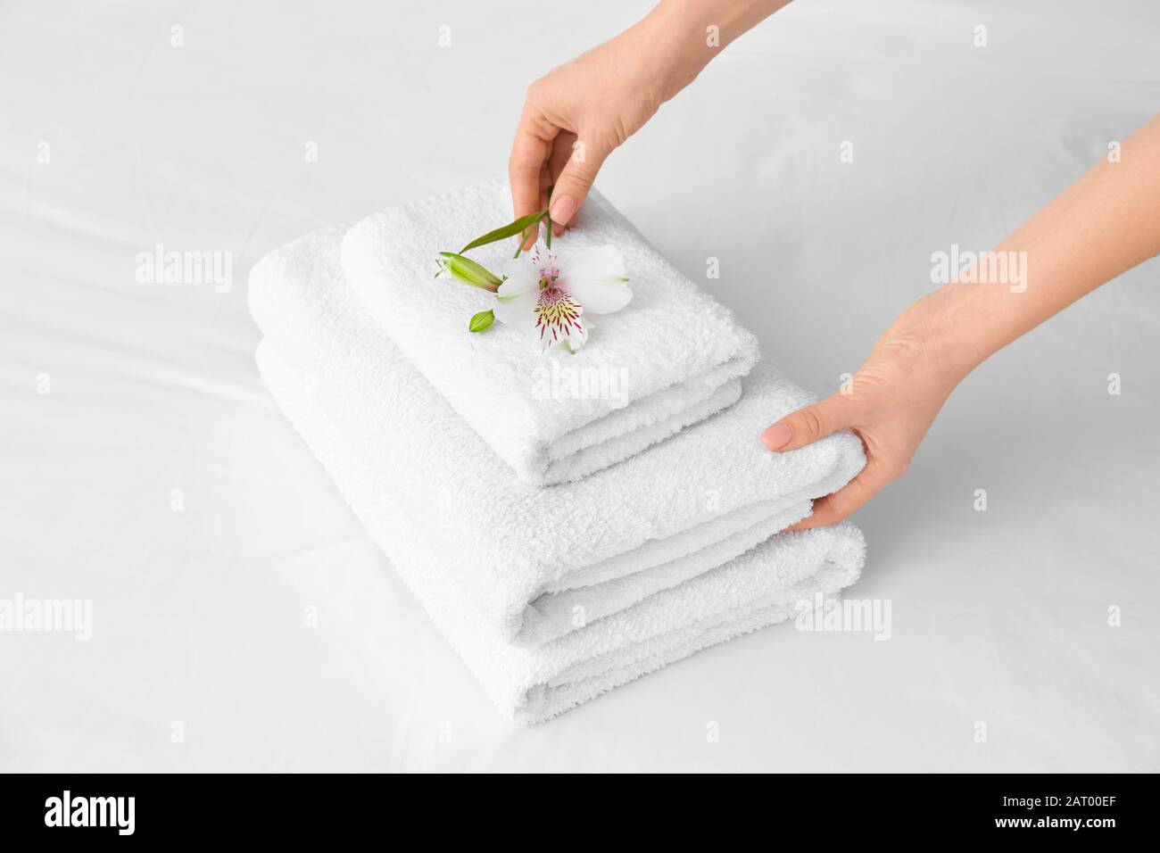 Woman putting stack clean hi-res stock photography and images - Alamy