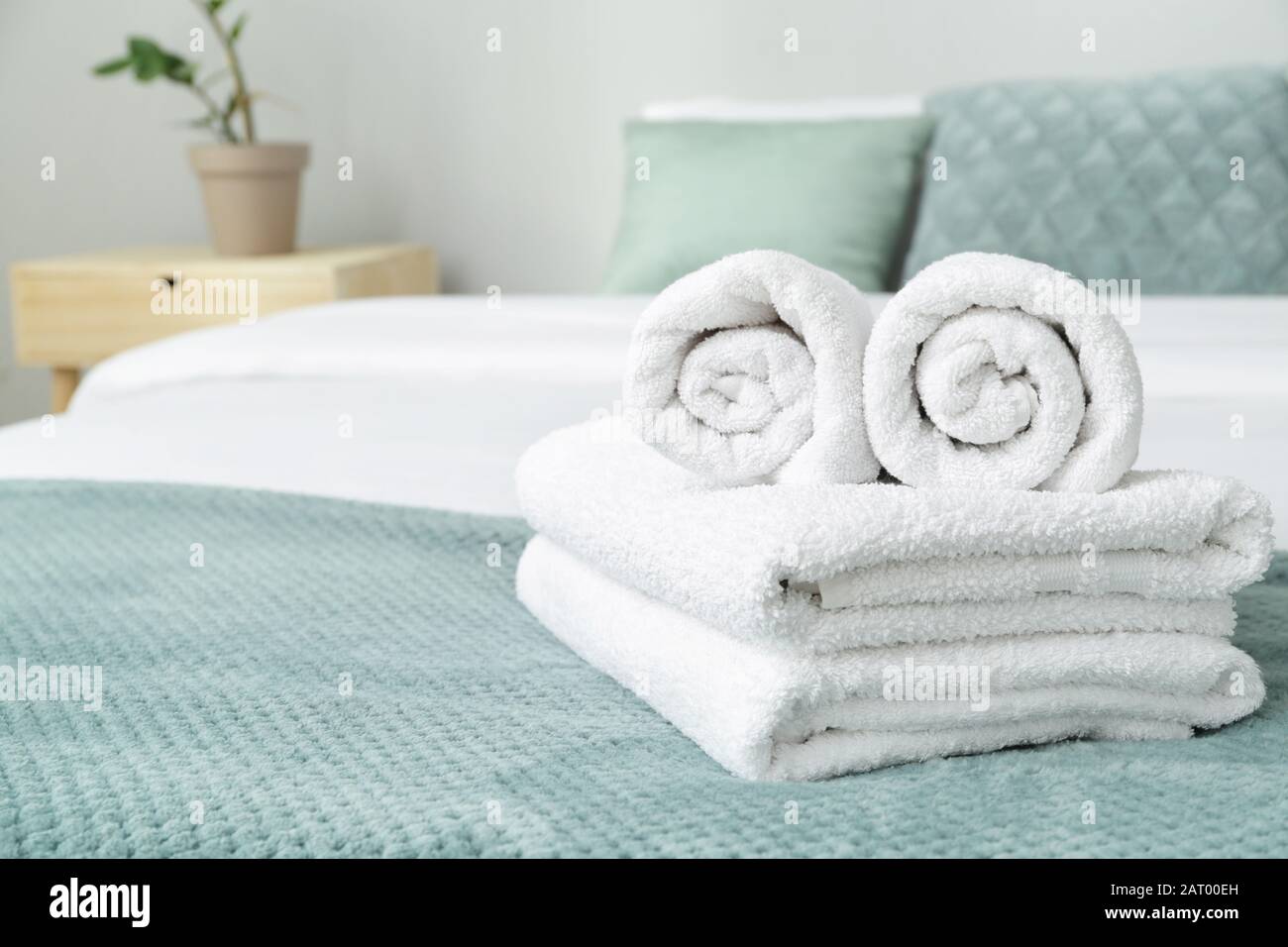 Clean soft towels on bed Stock Photo - Alamy