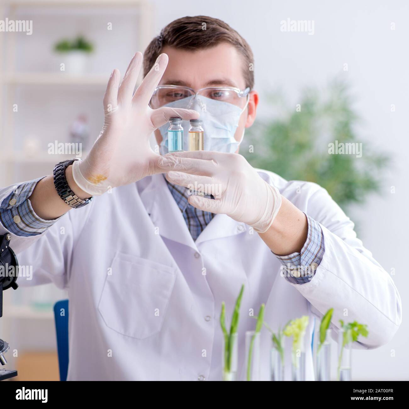 The male biochemist working in the lab on plants Stock Photo - Alamy