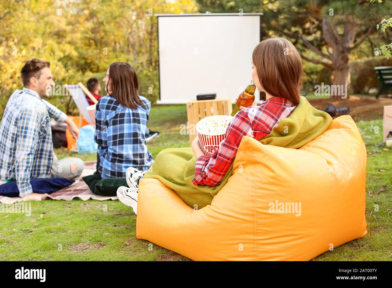 Friends watching movie in outdoor cinema Stock Photo - Alamy