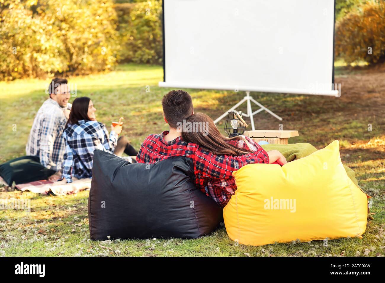 Friends watching movie in outdoor cinema Stock Photo - Alamy