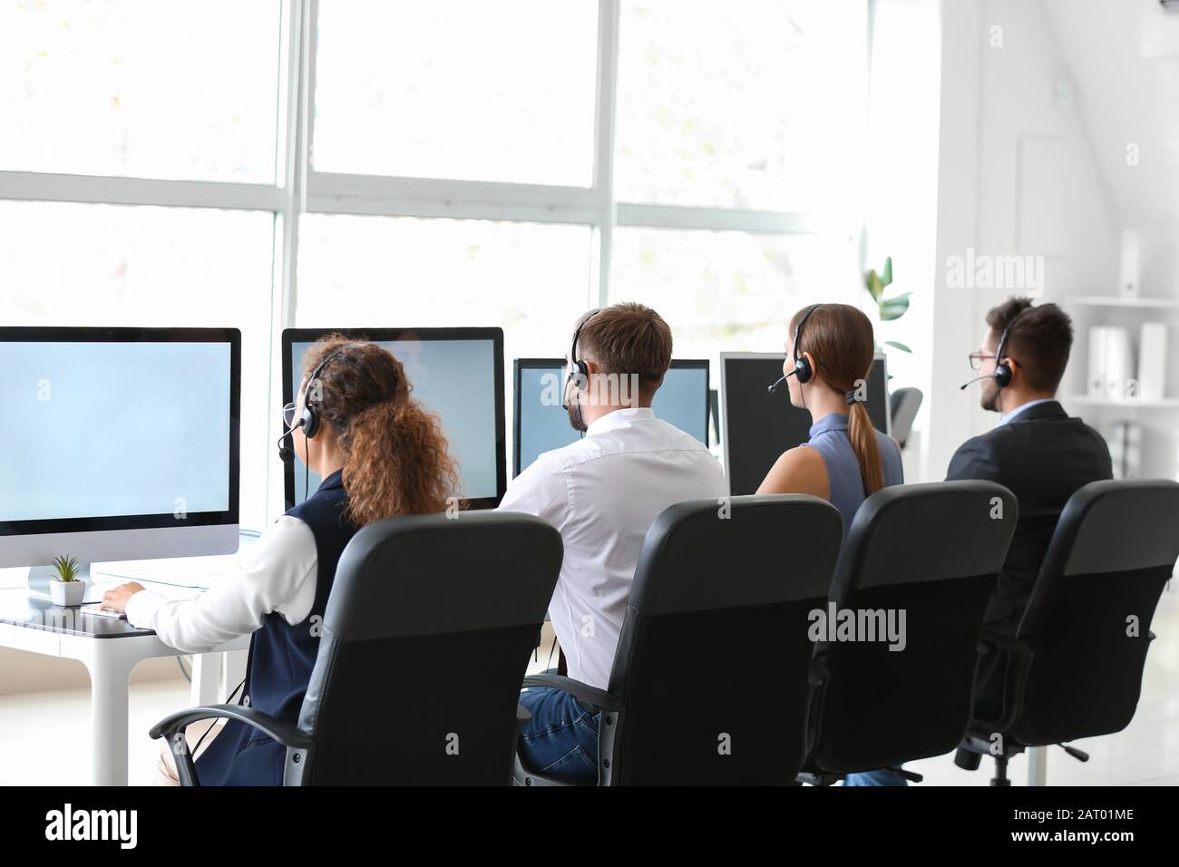 Technical support agents working in office Stock Photo - Alamy
