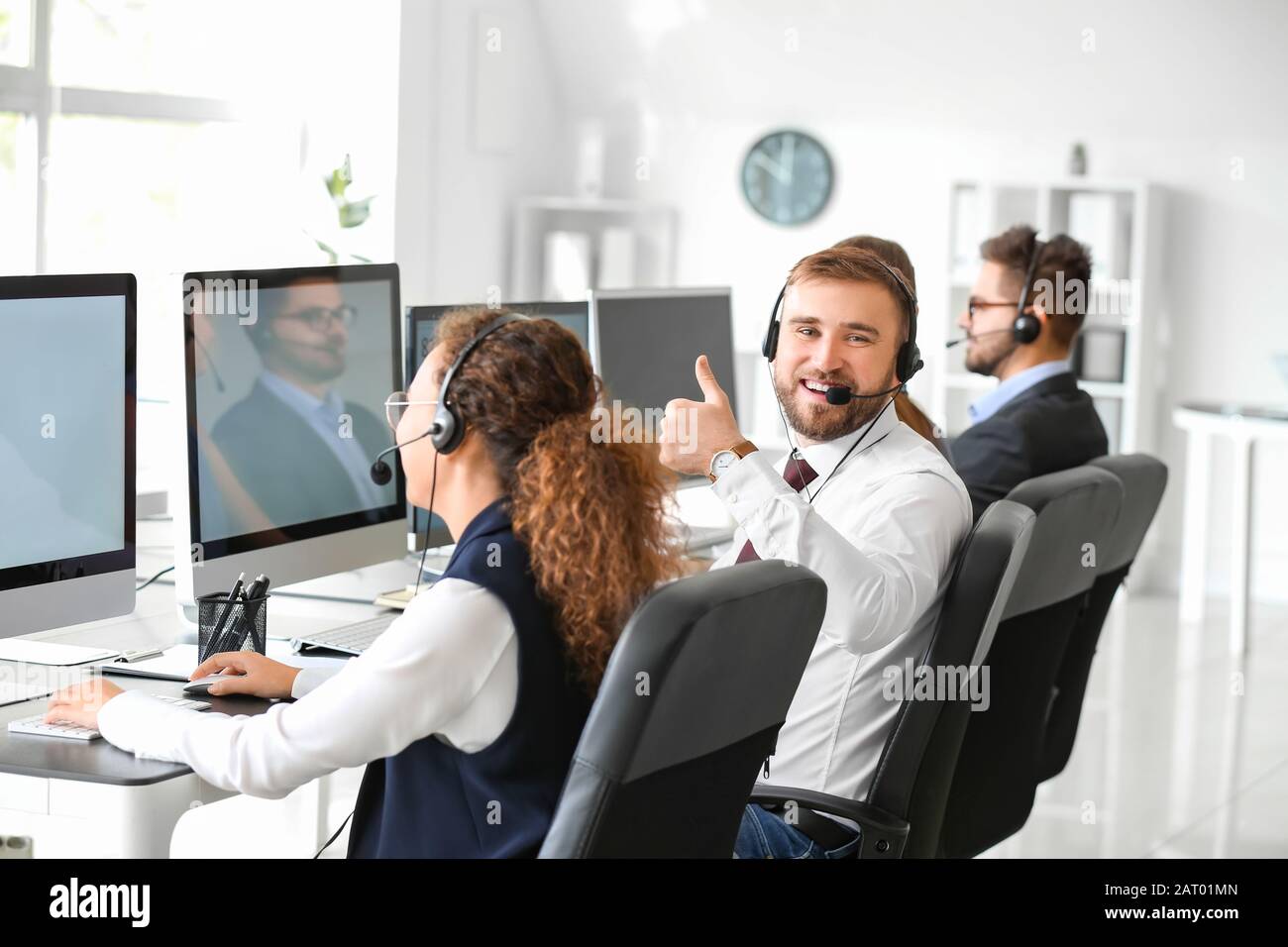 Technical support agents working in office Stock Photo - Alamy