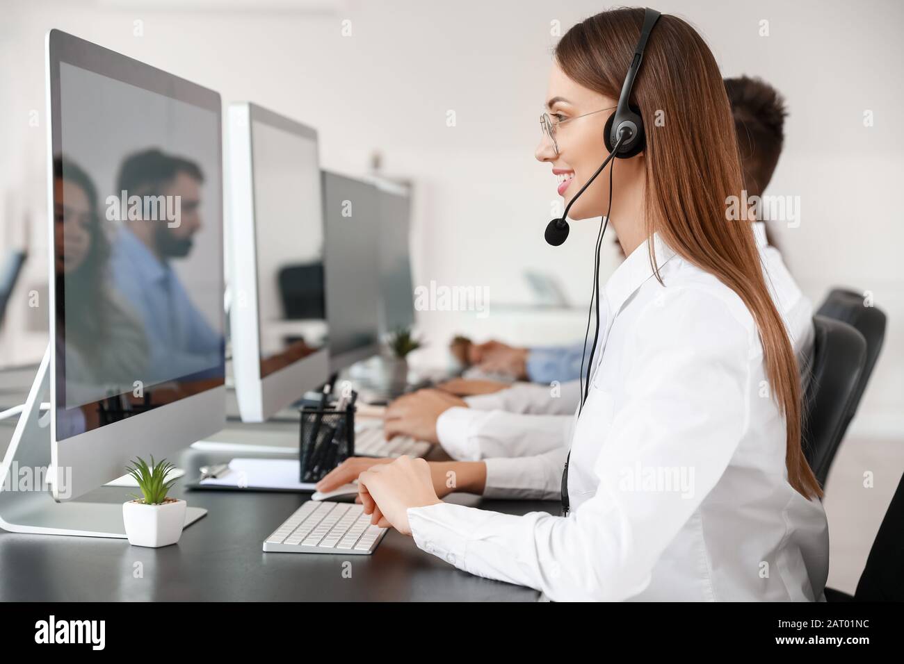 Technical support agents working in office Stock Photo - Alamy