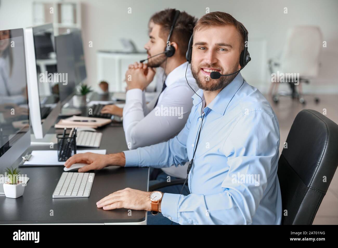 Technical support agents working in office Stock Photo - Alamy