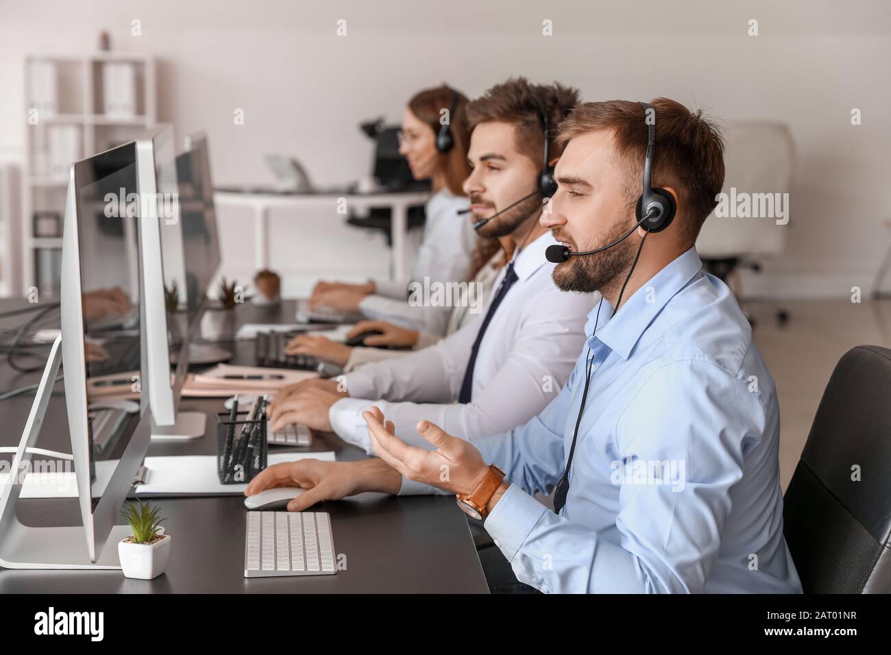 Technical support agents working in office Stock Photo - Alamy