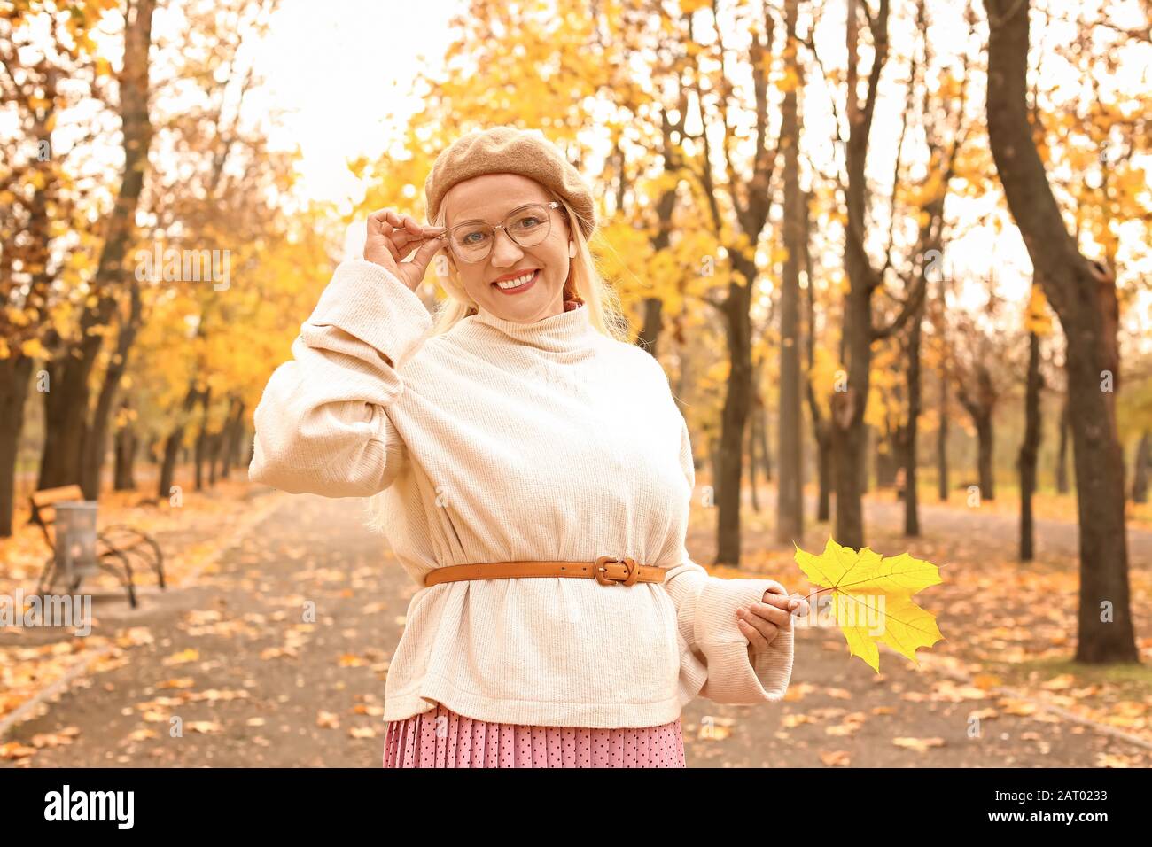 Beautiful mature woman in autumn park Stock Photo - Alamy