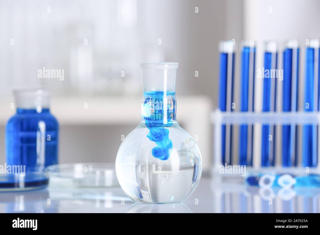 Flask with sample on table in laboratory Stock Photo - Alamy