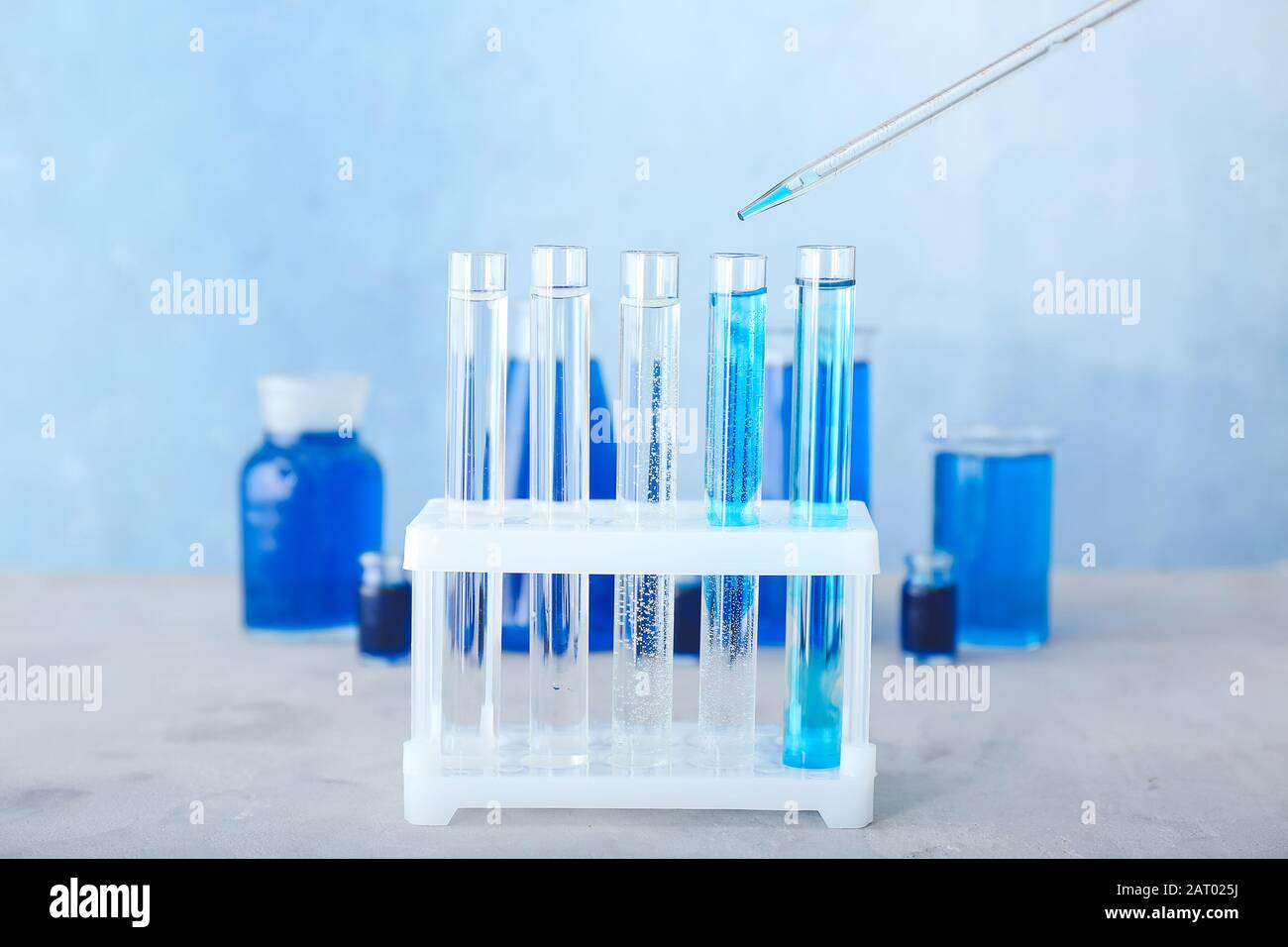 Dripping of color sample into test tube in laboratory Stock Photo - Alamy