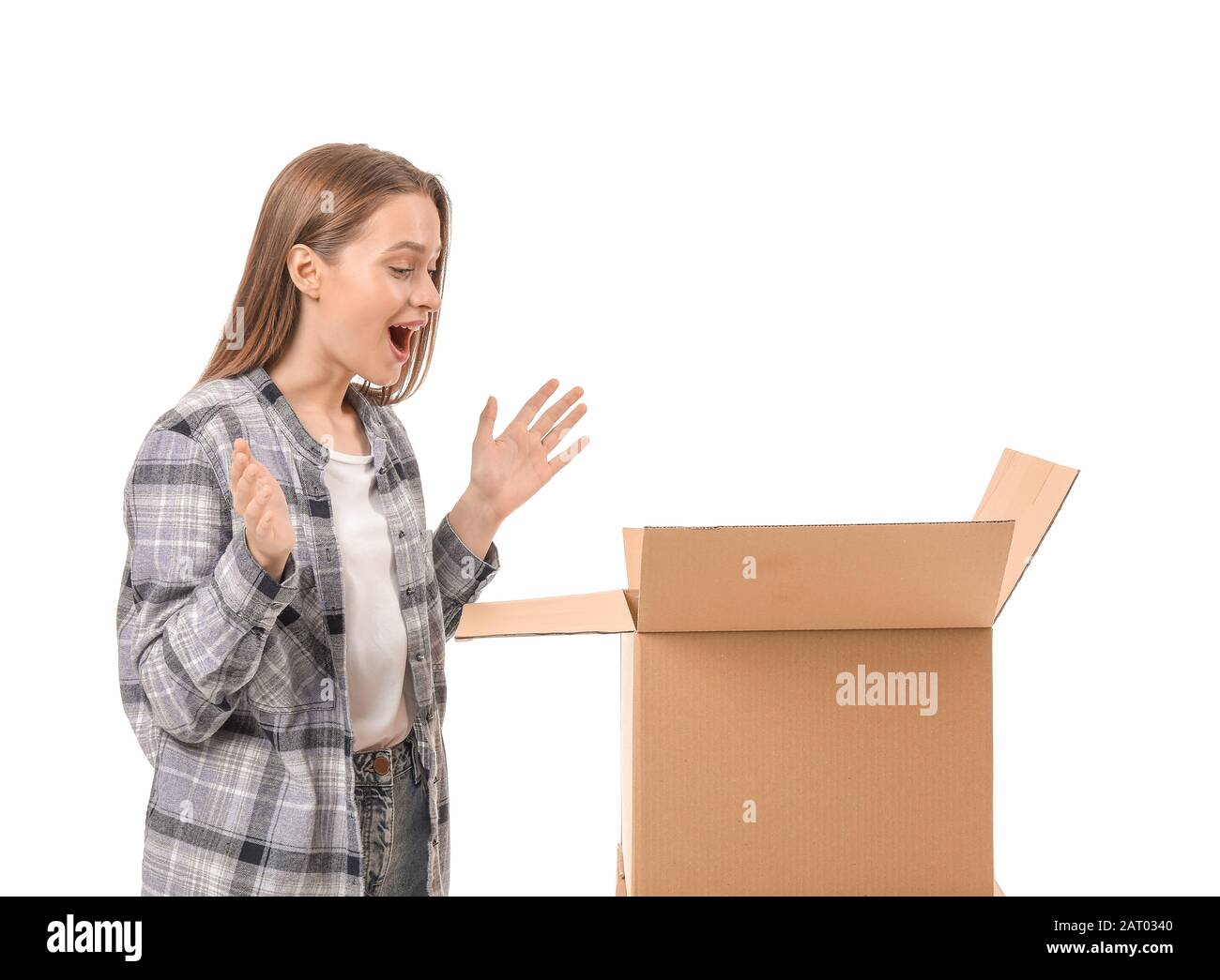 Excited young woman with open moving box on white background Stock ...