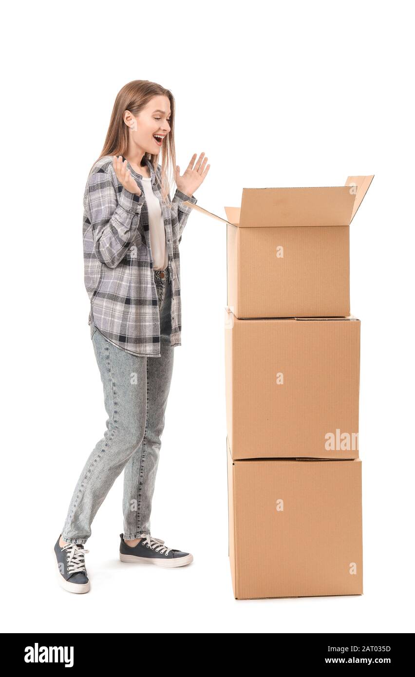 Surprised woman with moving boxes on white background Stock Photo - Alamy