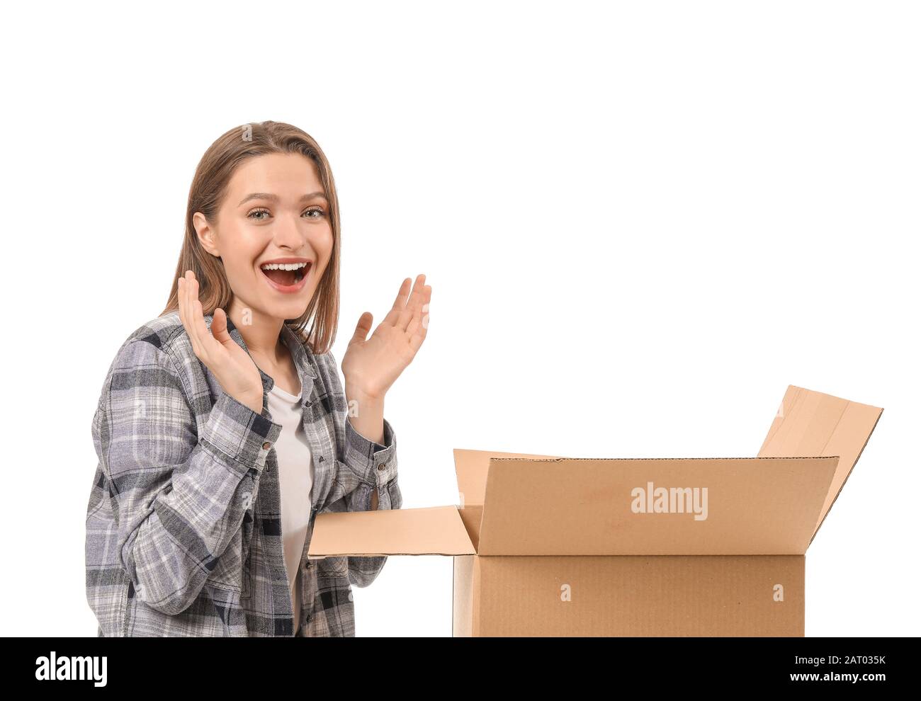 Excited young woman with open moving box on white background Stock ...