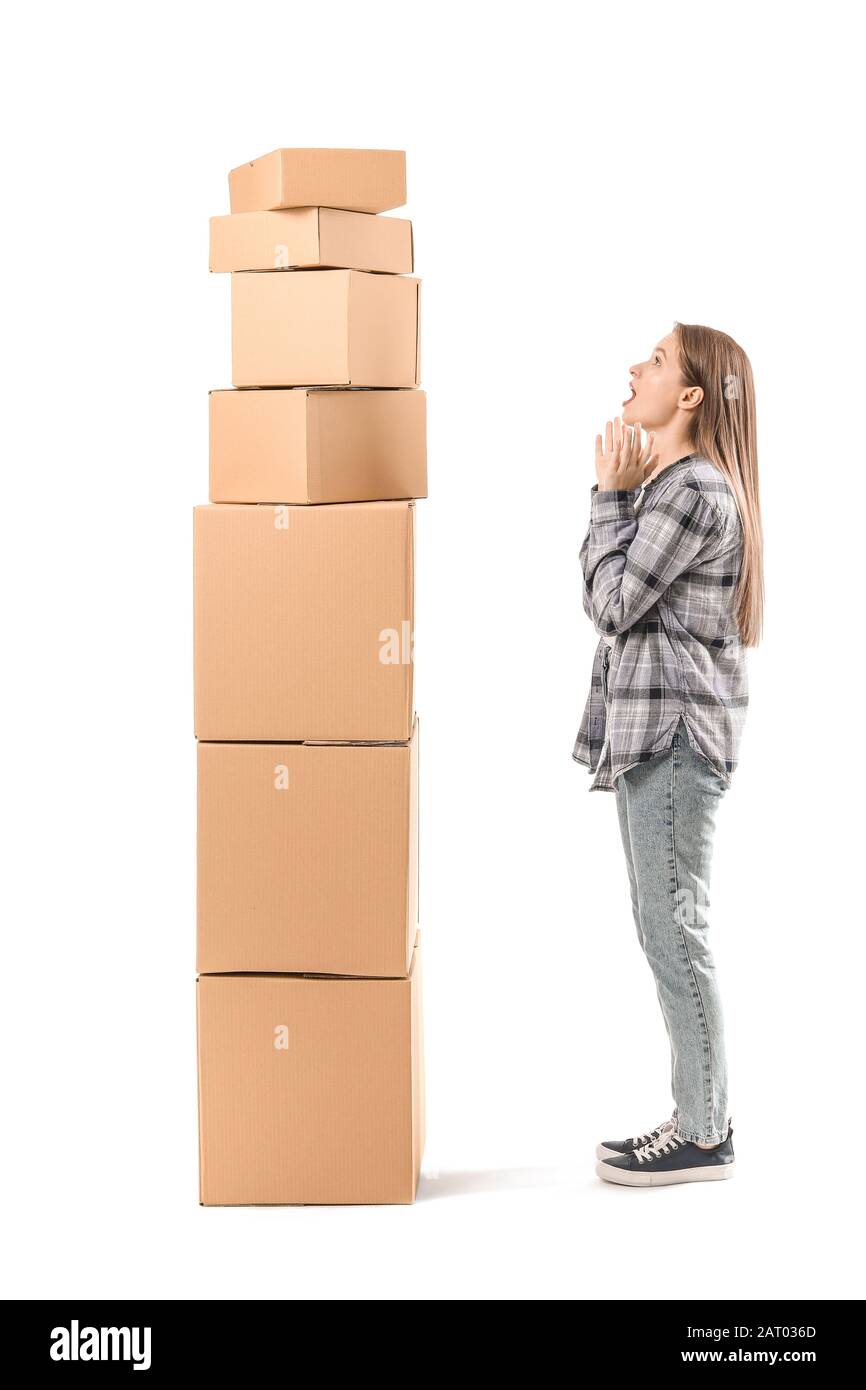 Shocked woman with moving boxes on white background Stock Photo - Alamy