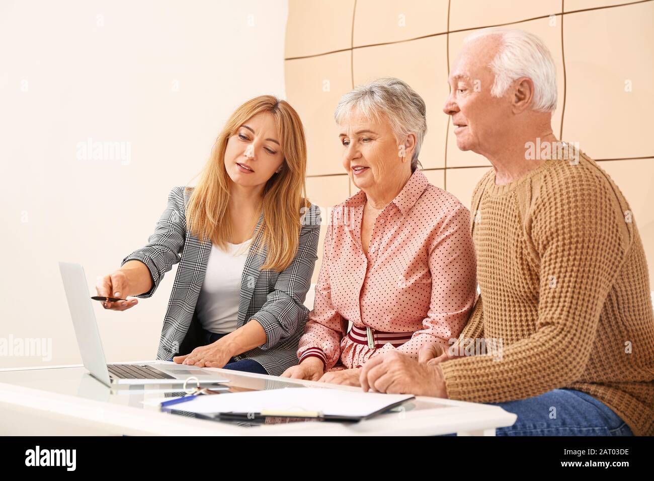 Female real estate agent working with senior couple indoors Stock Photo ...