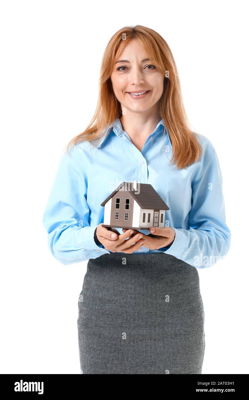 Female real estate agent with model of house on white background Stock ...