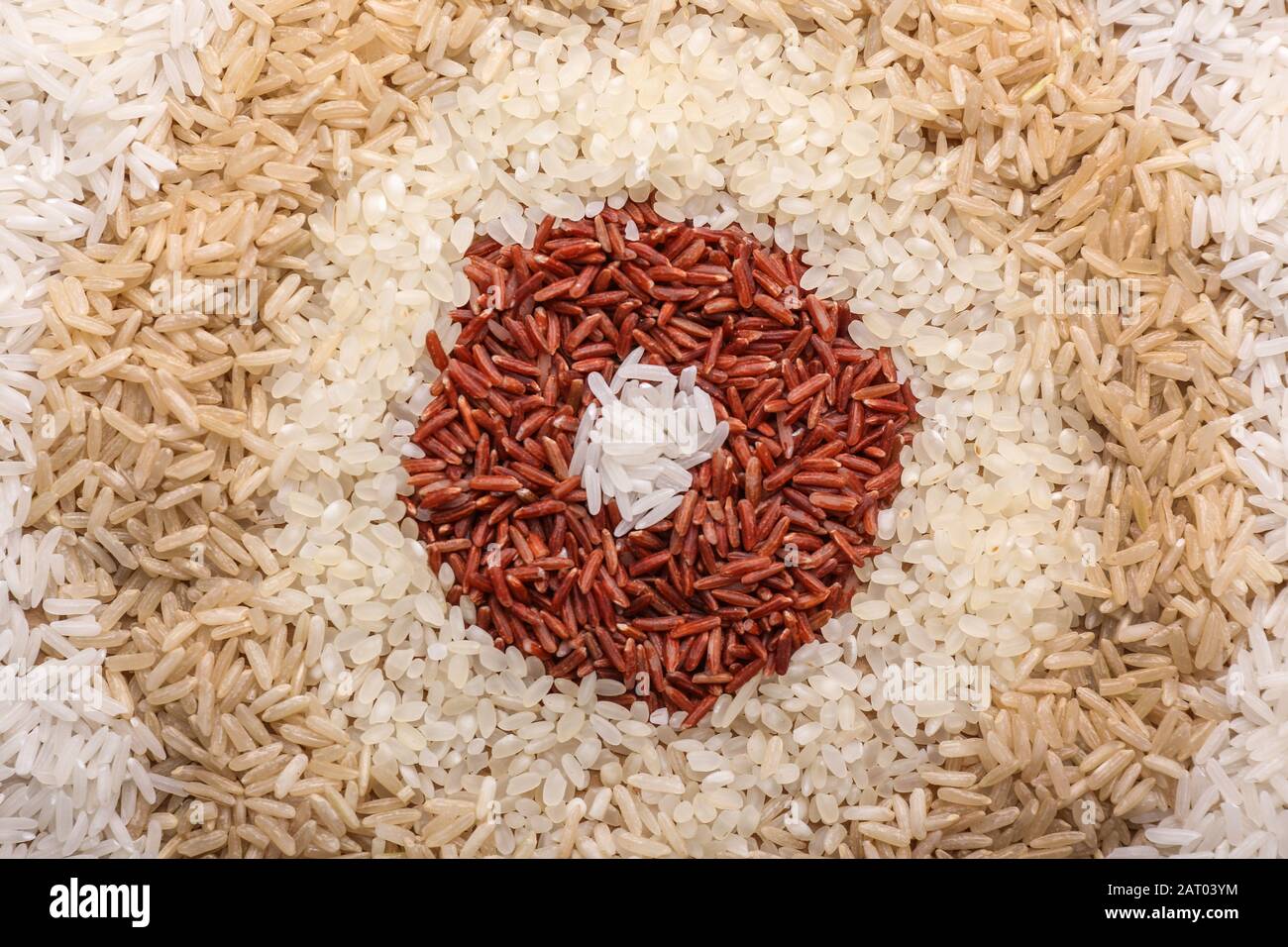 Different raw rice as background Stock Photo - Alamy
