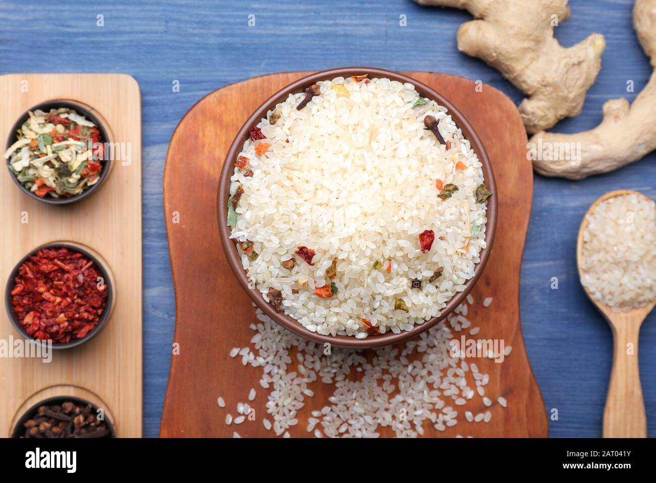 Raw rice with dry vegetables and spices on table Stock Photo - Alamy