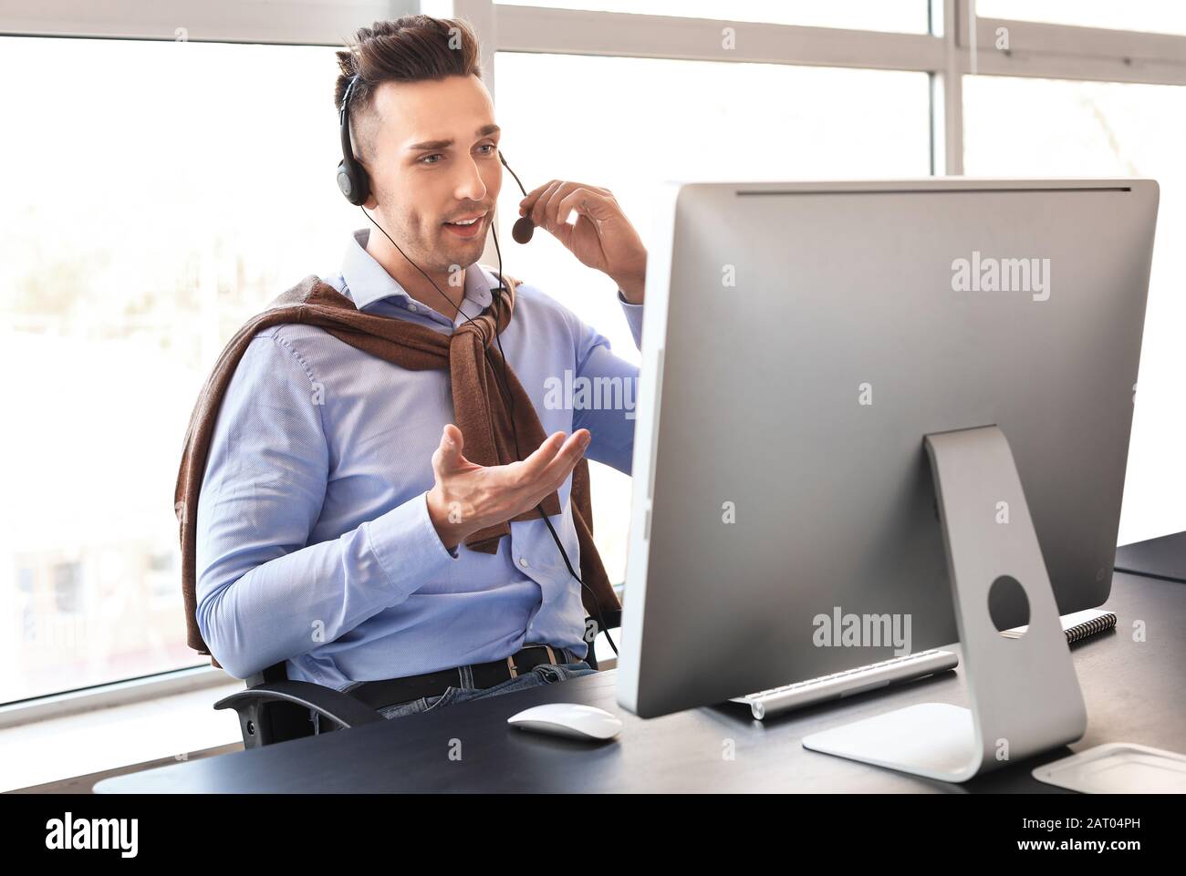 Male technical support agent working in office Stock Photo - Alamy