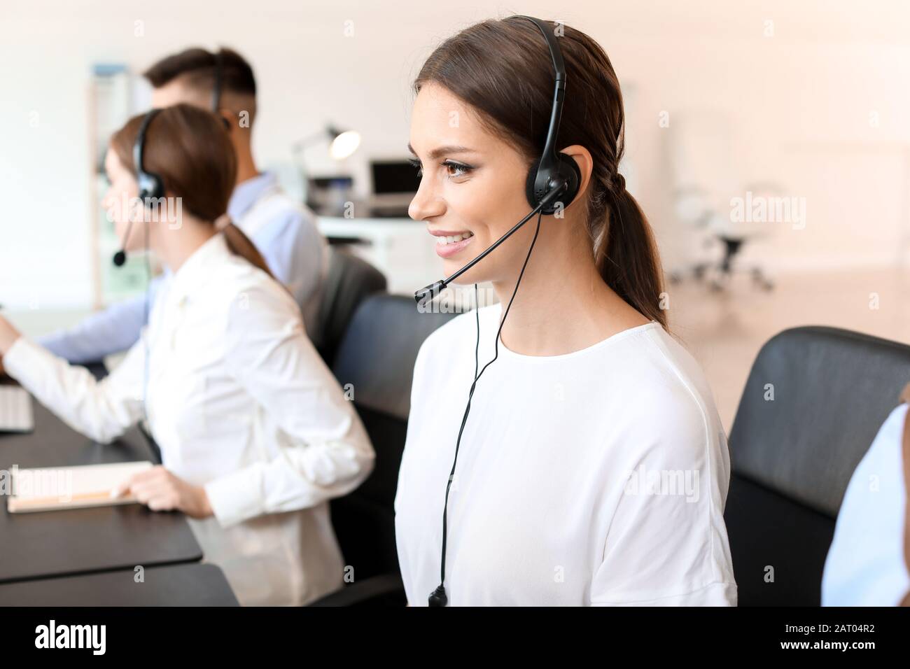 Female technical support agent working in office Stock Photo - Alamy