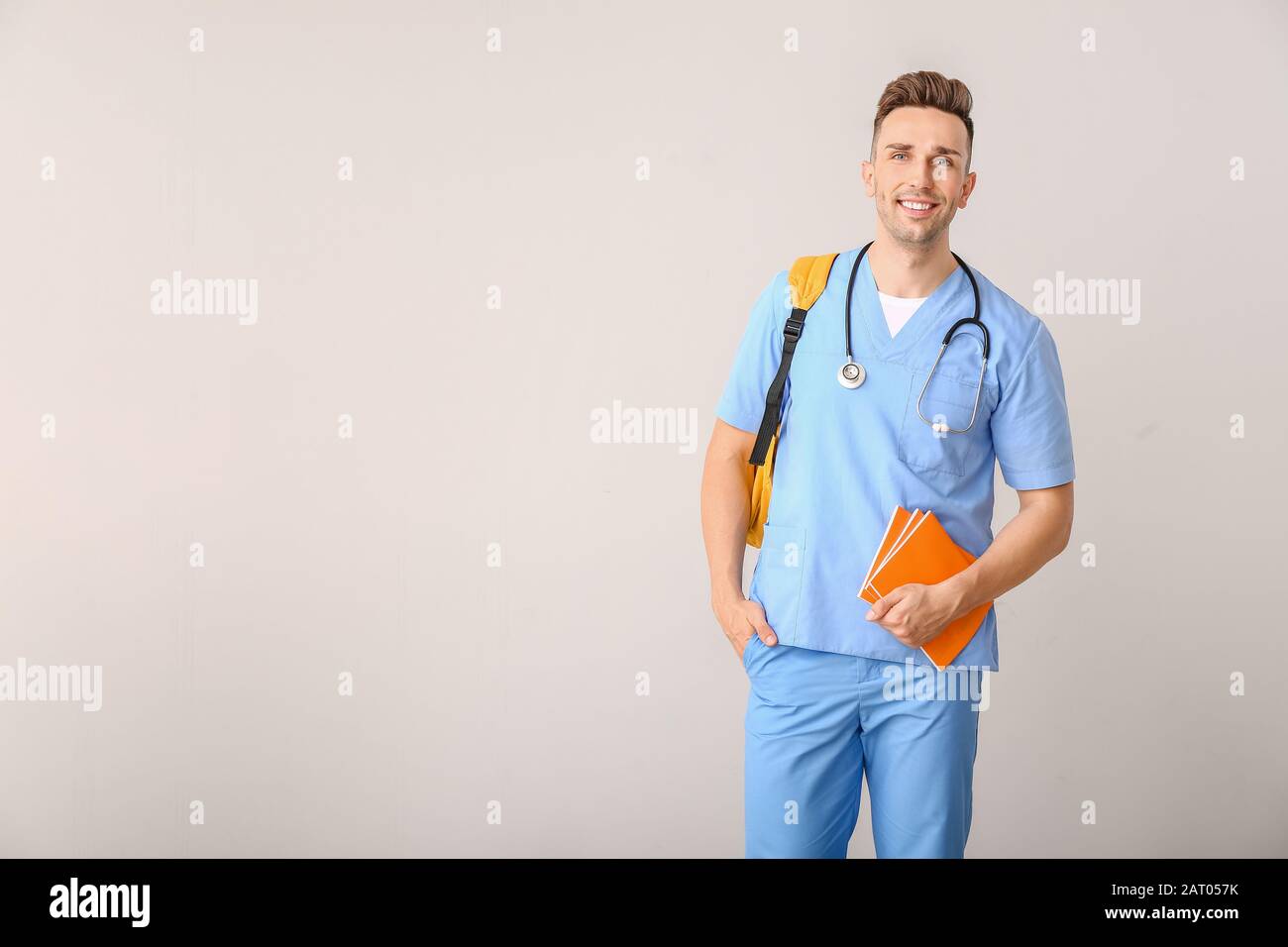 Male medical student on light background Stock Photo - Alamy