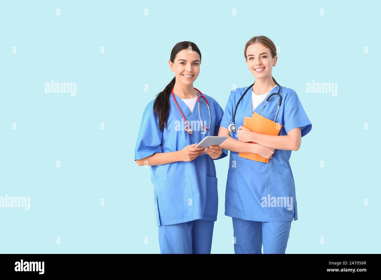 Female medical students on color background Stock Photo - Alamy