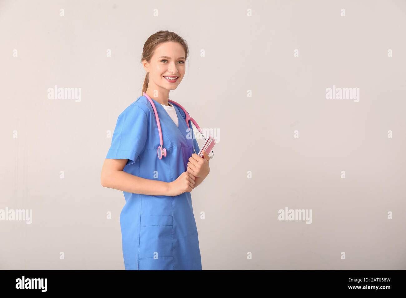 Female medical student on light background Stock Photo - Alamy