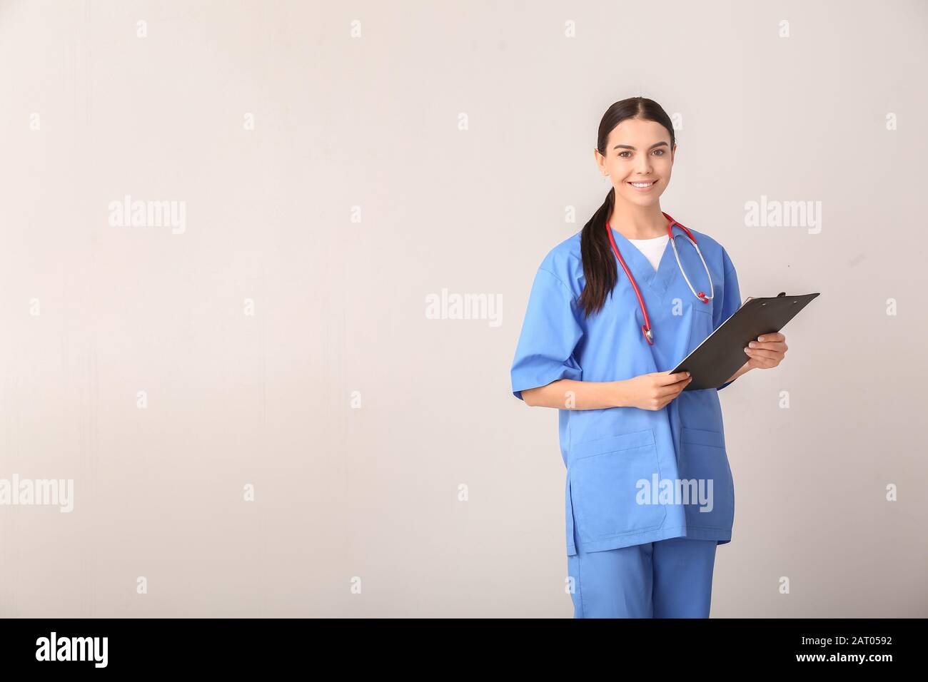 Female medical student on light background Stock Photo - Alamy