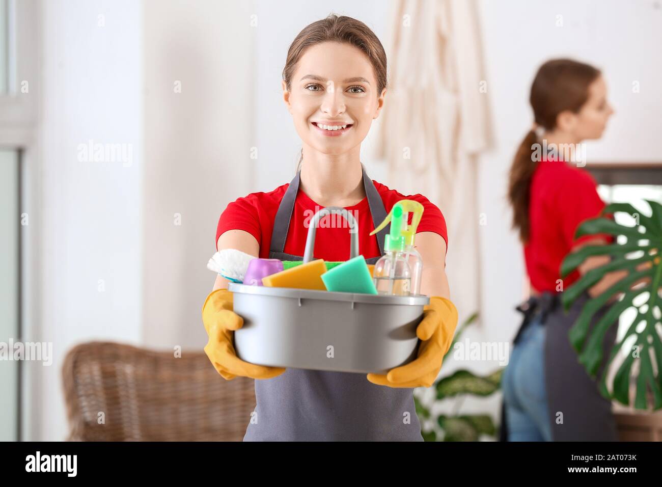 Janitor with cleaning supplies in bathroom Stock Photo - Alamy