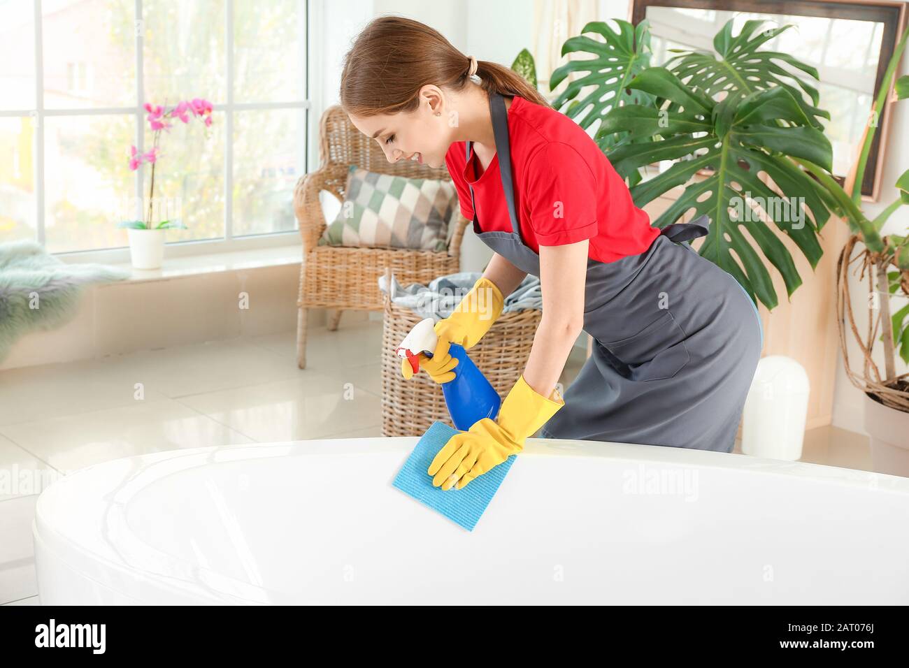 Janitor doing cleanup in bathroom Stock Photo - Alamy