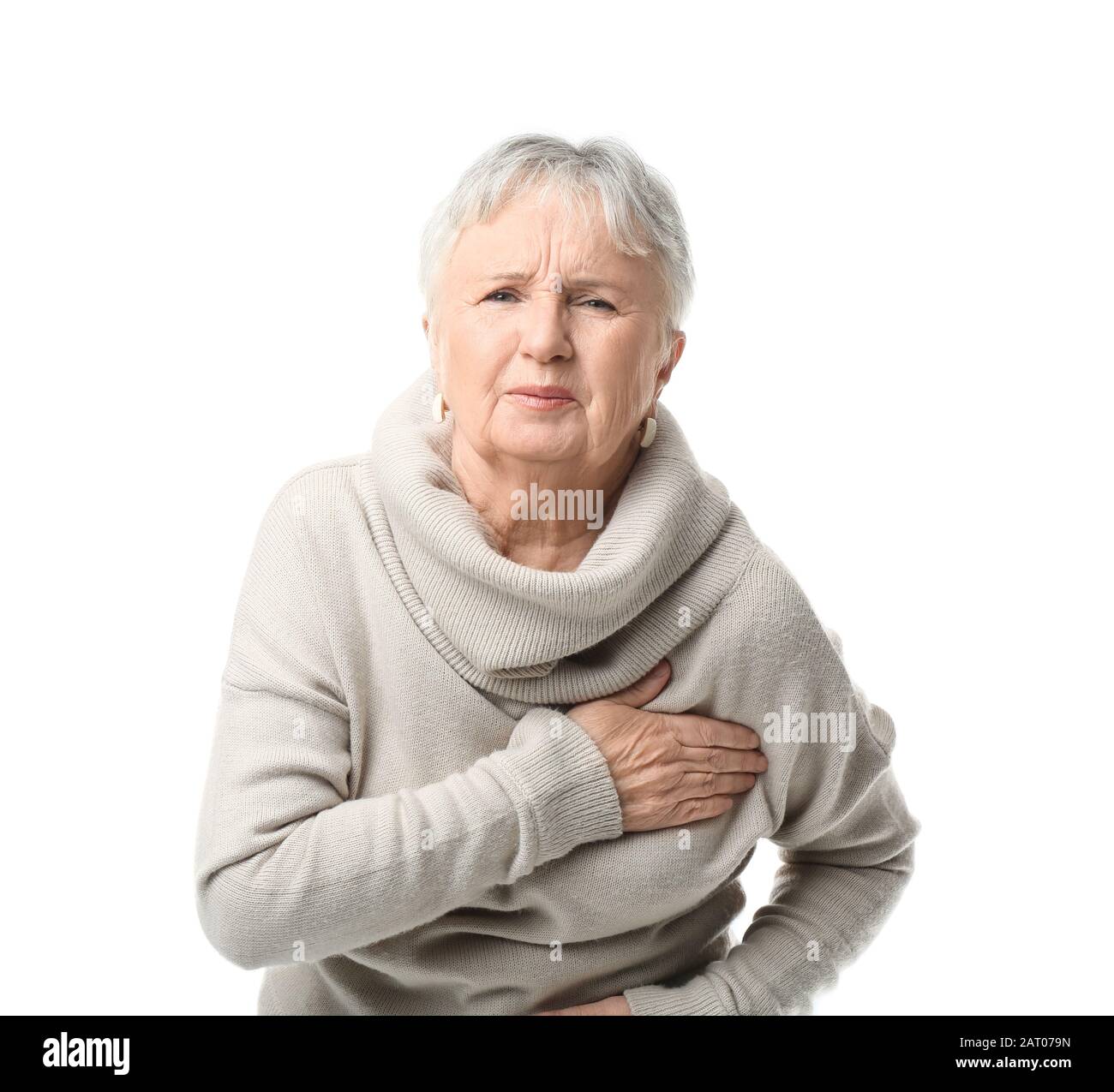 Senior woman suffering from heart attack on white background Stock ...