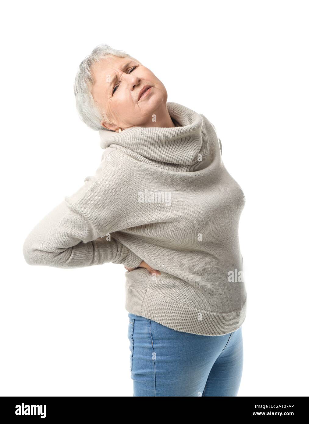 Senior woman suffering from back pain on white background Stock Photo ...