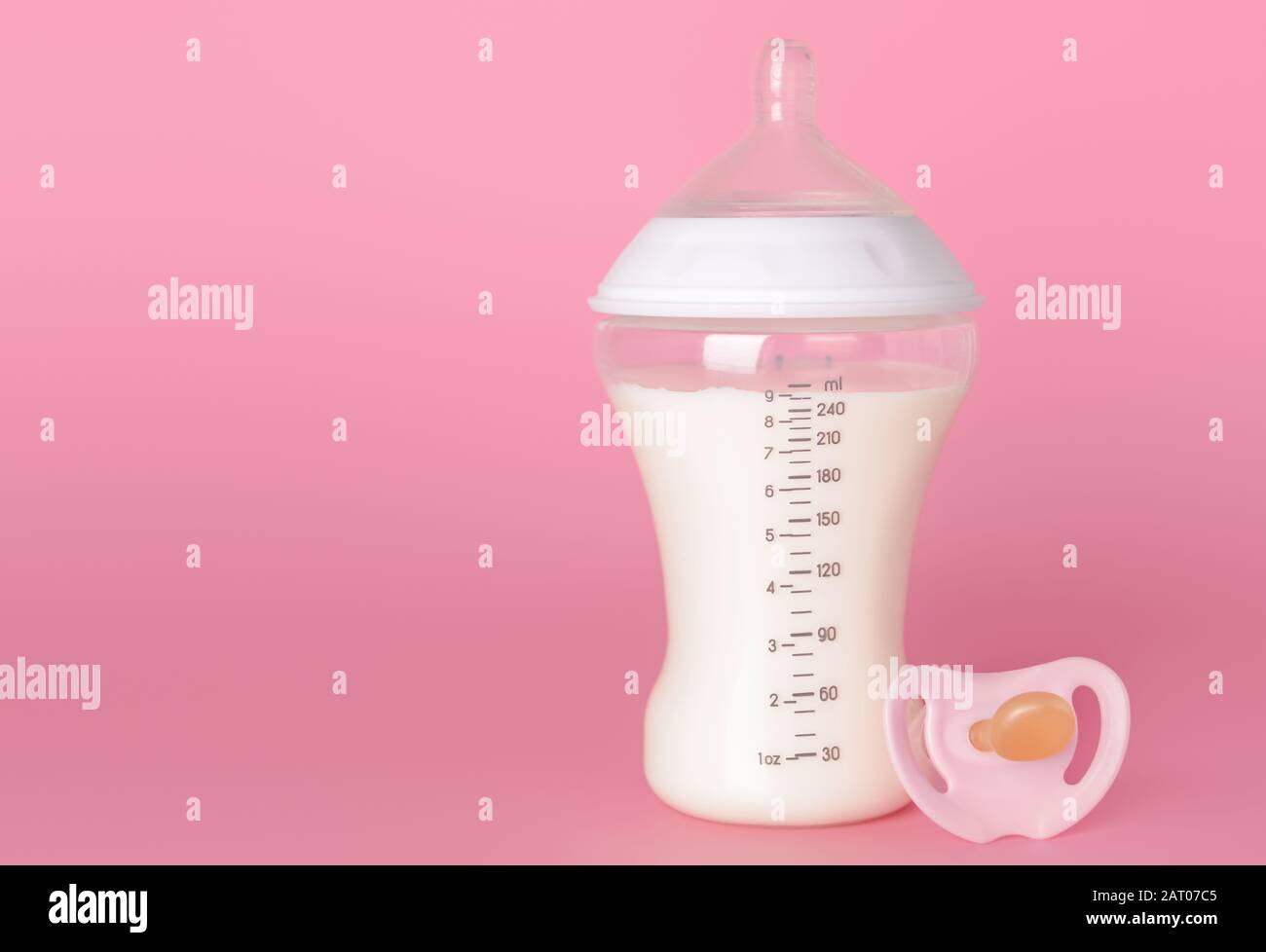 Bottle of milk for baby and pacifier on color background Stock Photo ...