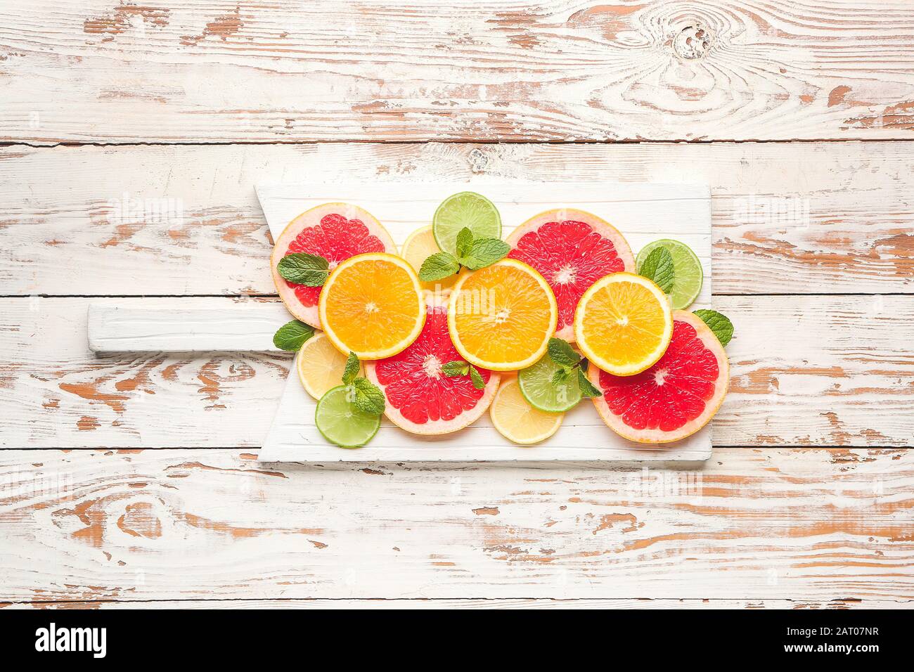 Fresh cut citrus fruits on wooden background Stock Photo - Alamy