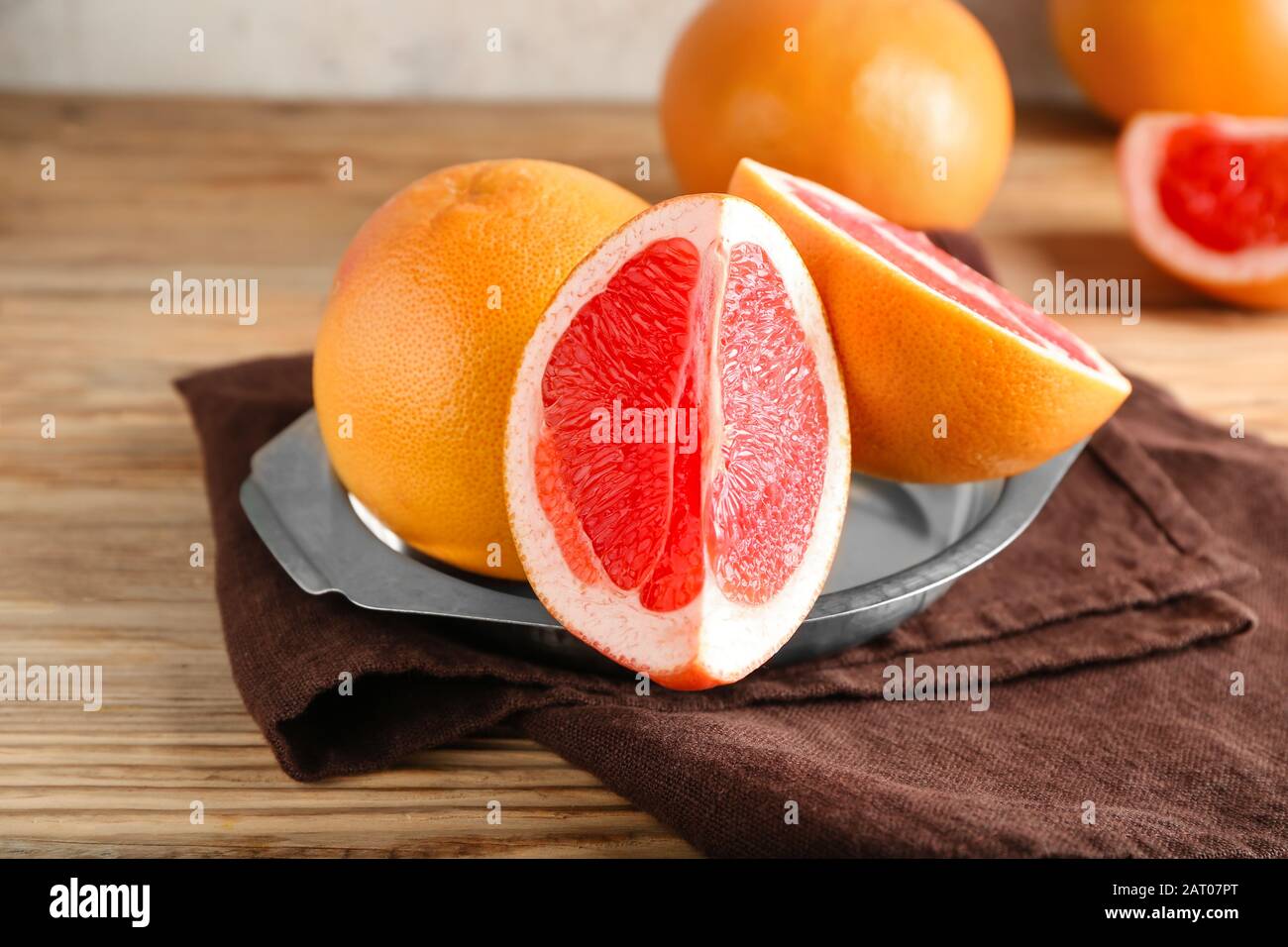 Fresh cut grapefruit on table Stock Photo - Alamy