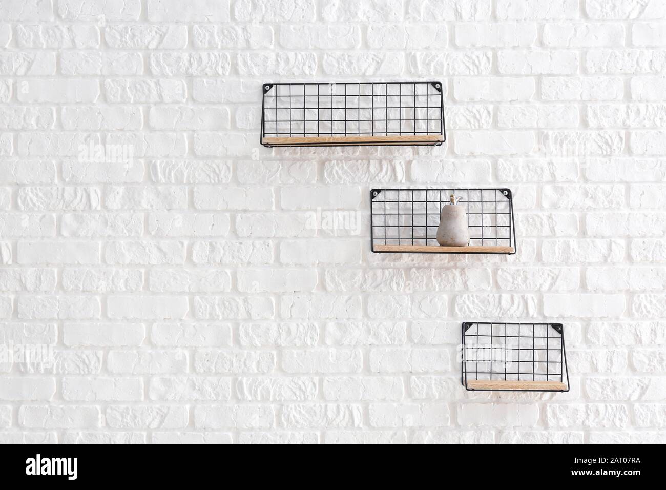 Hanging shelves on brick wall hi-res stock photography and images - Alamy
