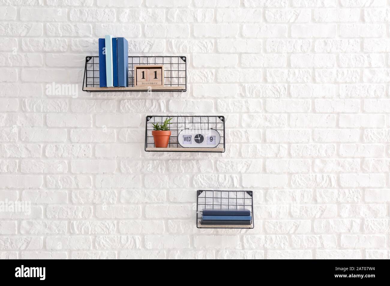 Hanging shelves on brick wall hi-res stock photography and images - Alamy