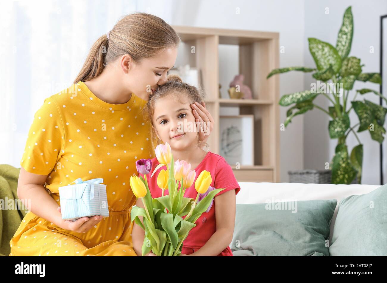 Little girl greeting her mother at home Stock Photo - Alamy