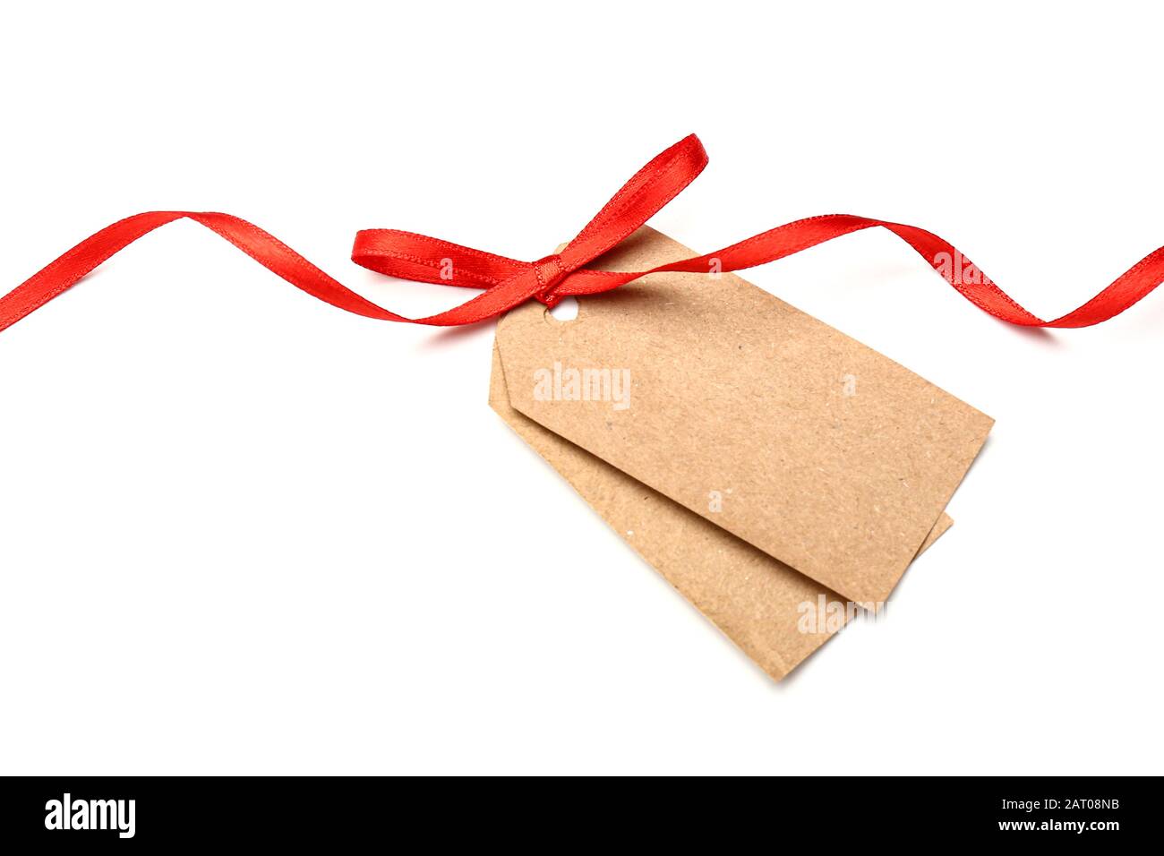 Beautiful red ribbon and blank tags on white background Stock Photo - Alamy